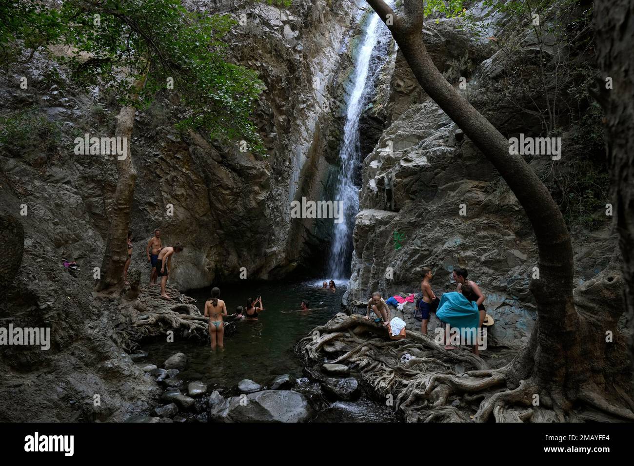 Tourist enjoy the Myllomeris waterfalls near Platres village, on ...