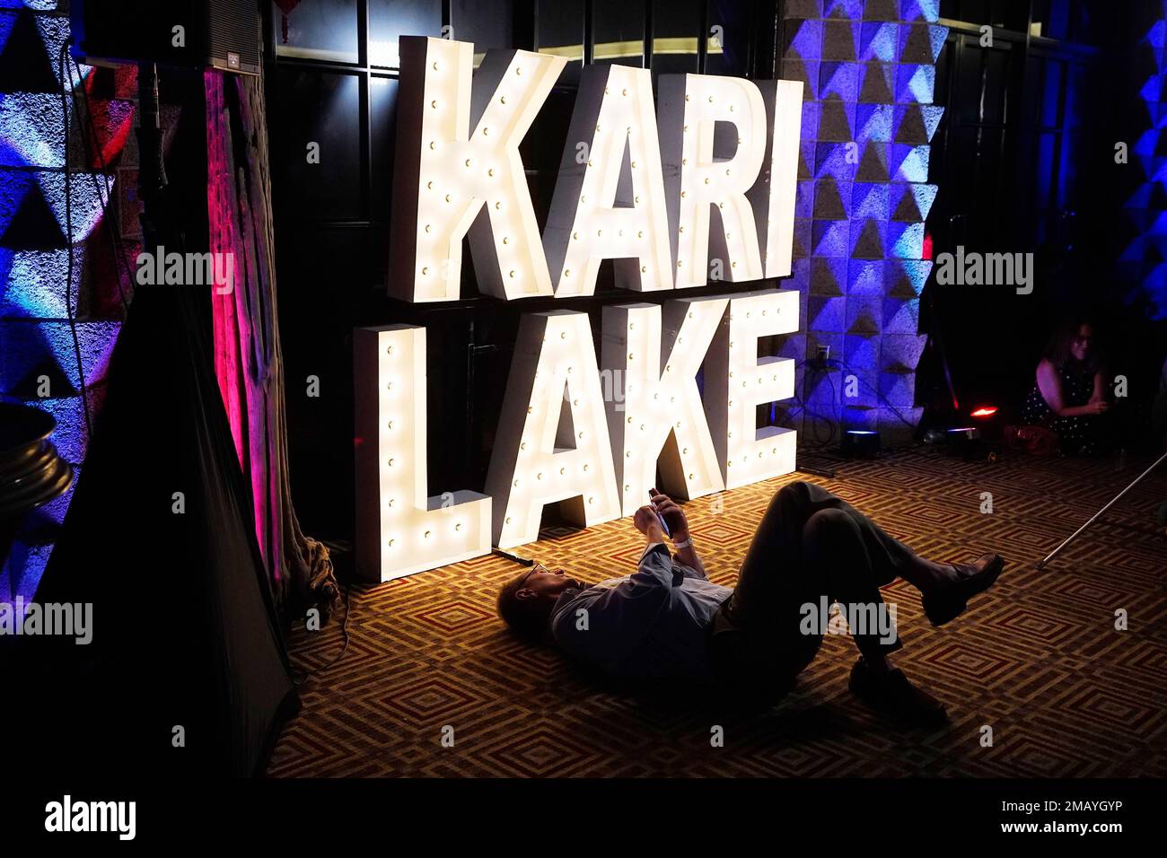 Curt Bruggman checks his phone as supporters wait for Kari Lake ...