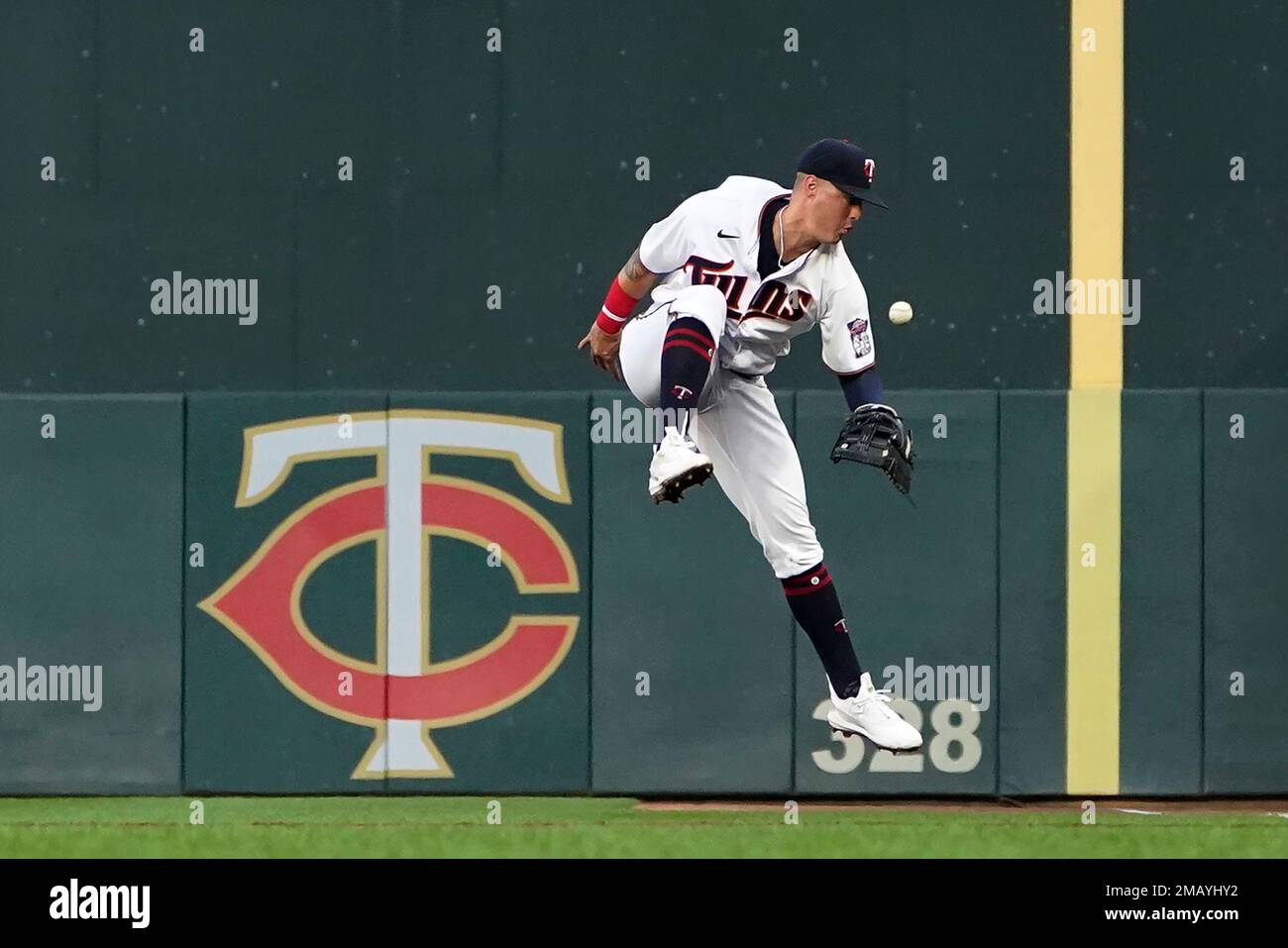 Minnesota Twins first baseman Jose Miranda is unable to make the play ...