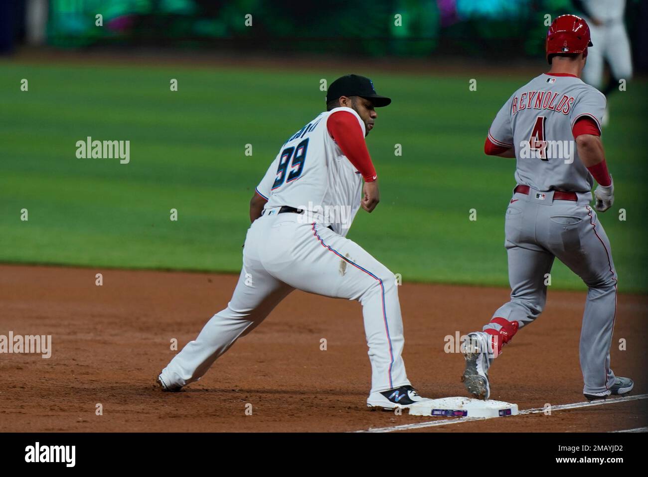 Cincinnati Reds' Matt Reynolds (4) is safe at first as Miami Marlins ...