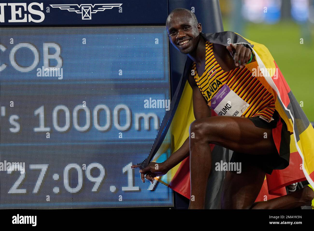 Uganda's Jacob Kiplimo points at the scoreboard as he celebrates after ...