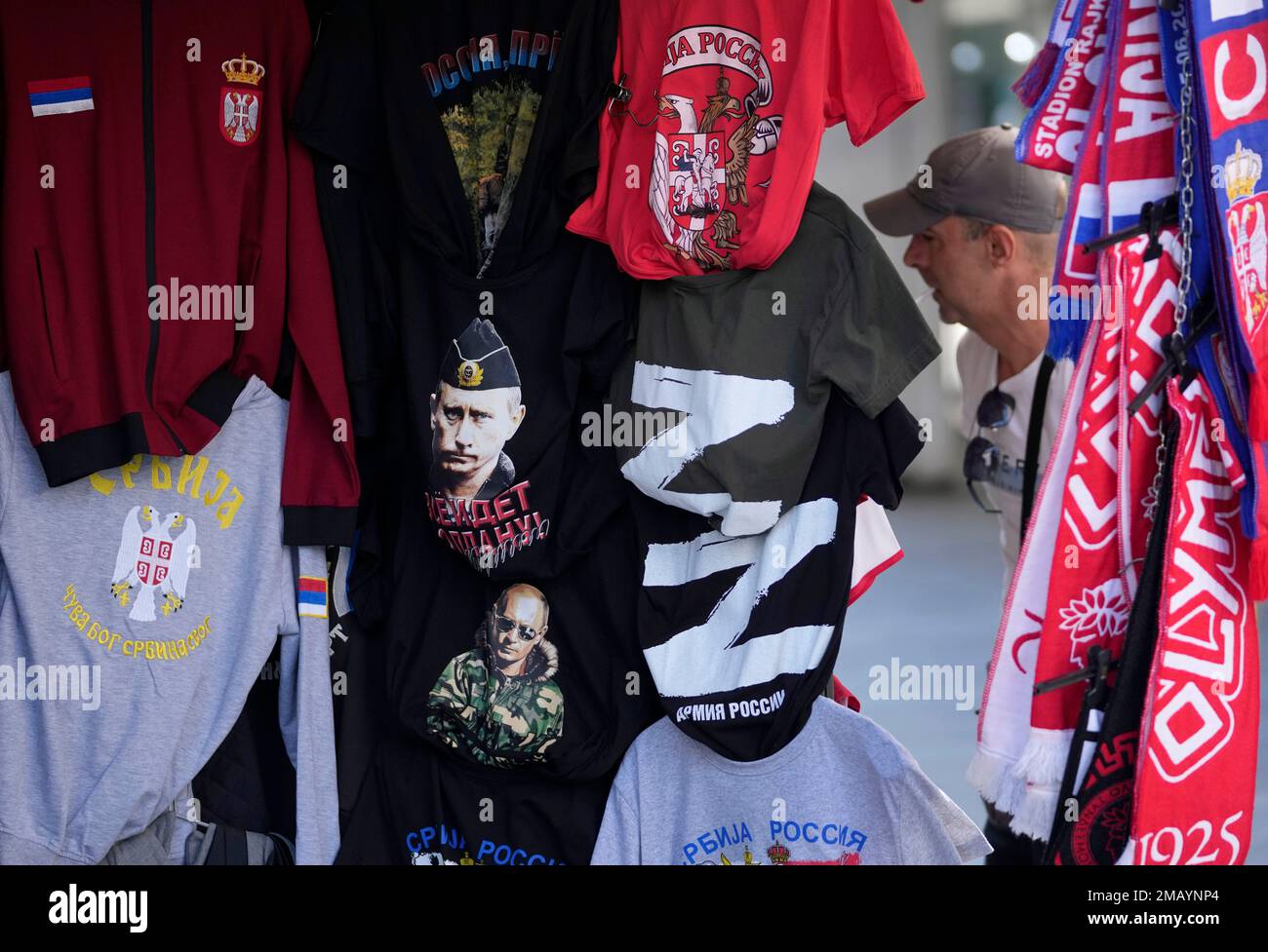 A street vendor sells shirts with a picture of Russian President ...