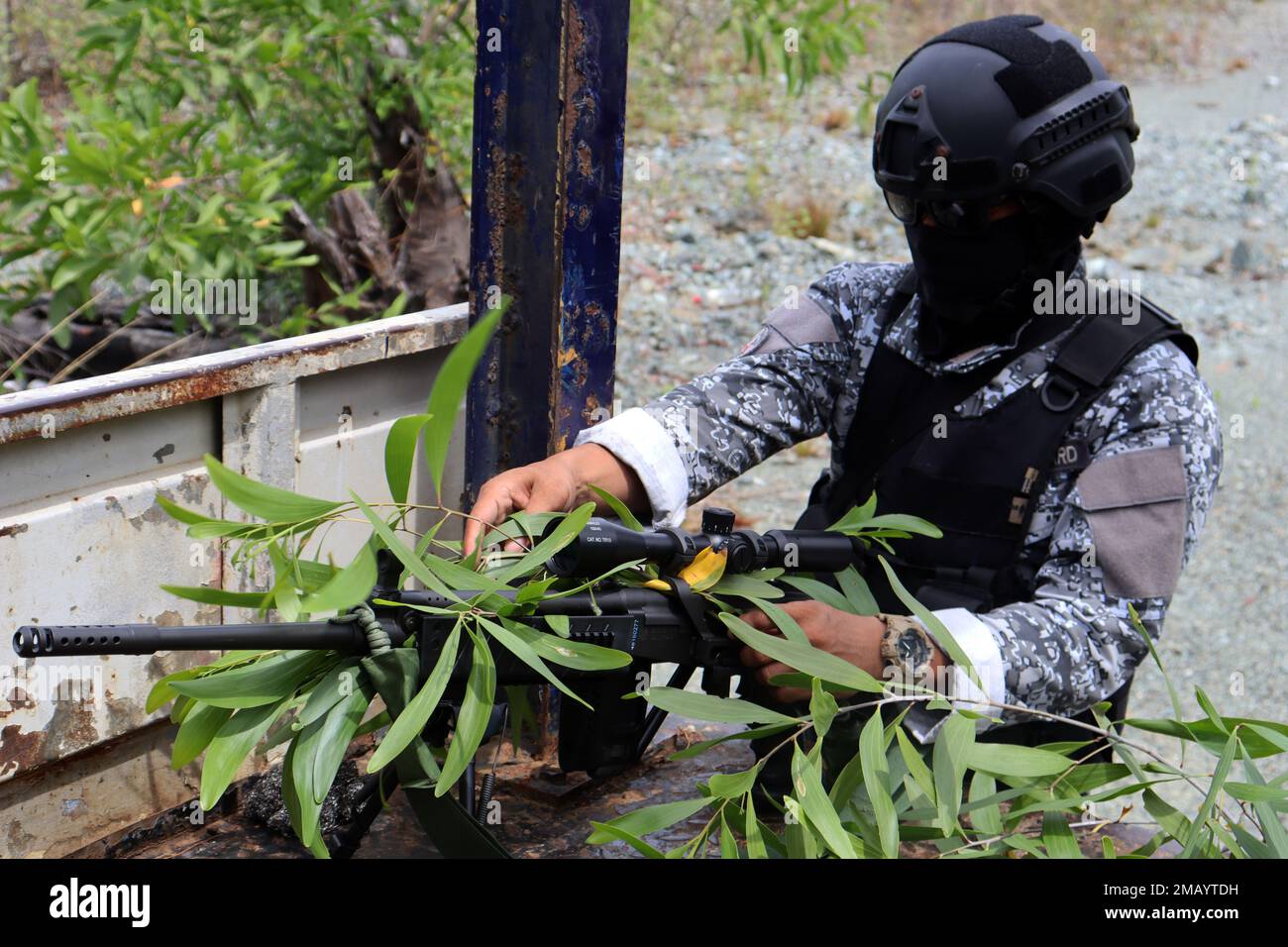A Philippine Coast Guard Special Operations Force member camouflages ...