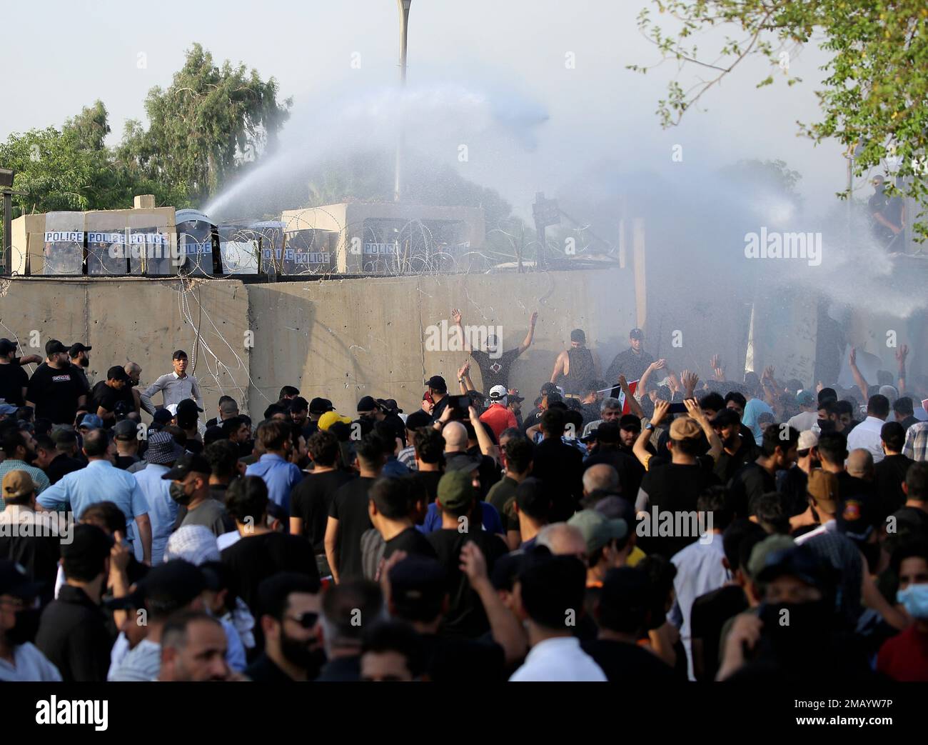Iraqi security forces spray supporters of a political alliance of Iran ...