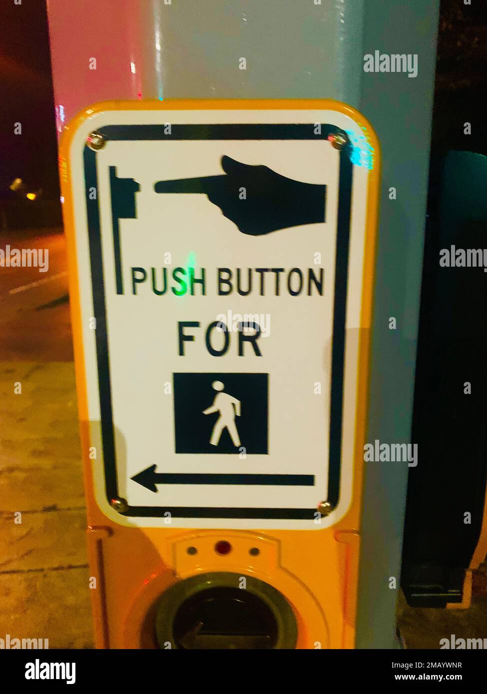 A vertical shot of a Push button sign for a pedestrian street light on ...