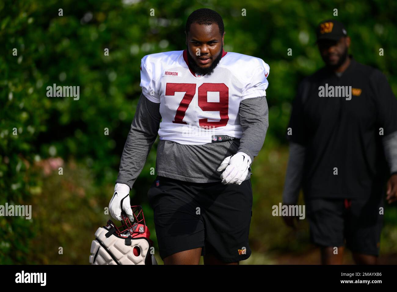 Washington Commanders' Tyrese Robinson makes his way to the field ...