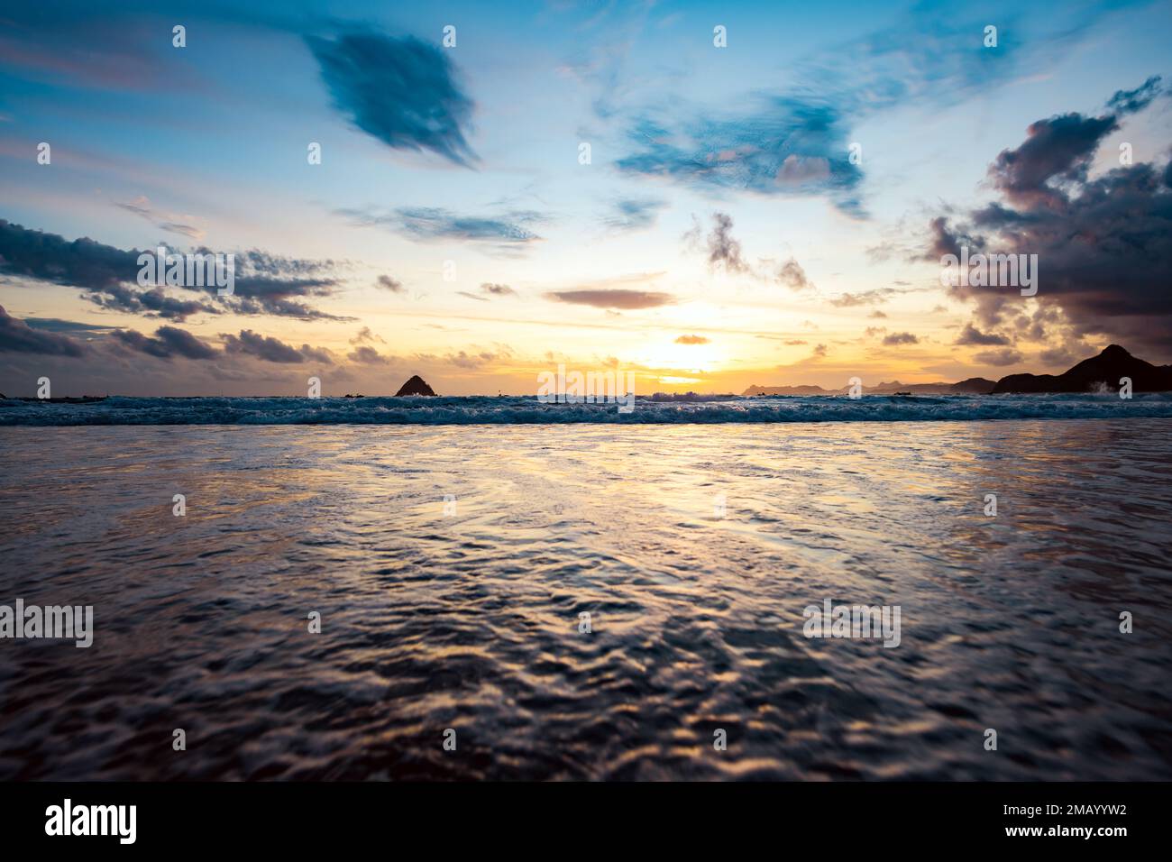 Stunning seascape with some waves crashing on a beach during a ...