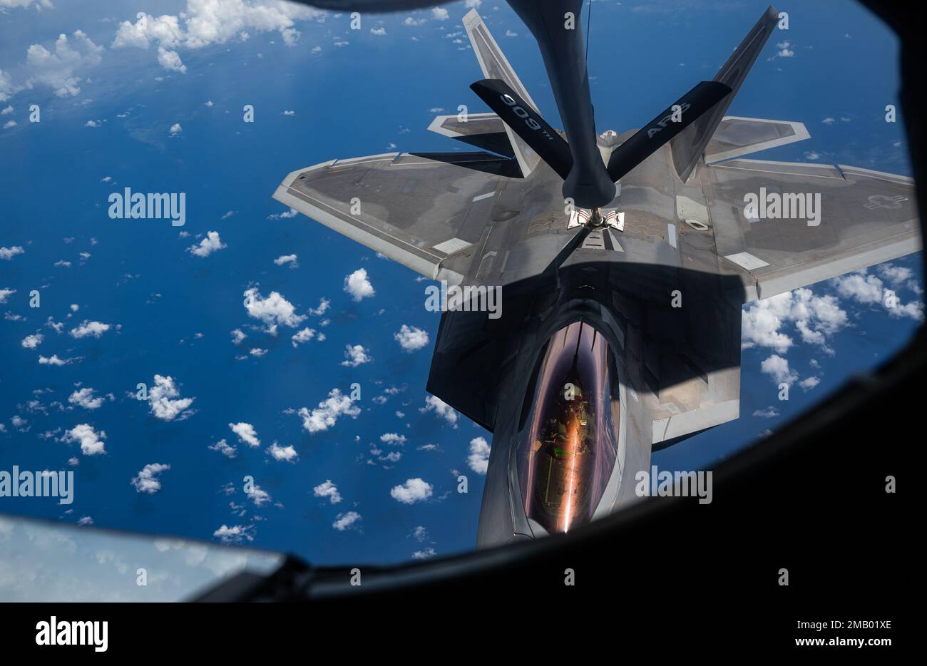 A 199th Fighter Squadron F-22A Raptor approaches a 909th Air Refueling ...