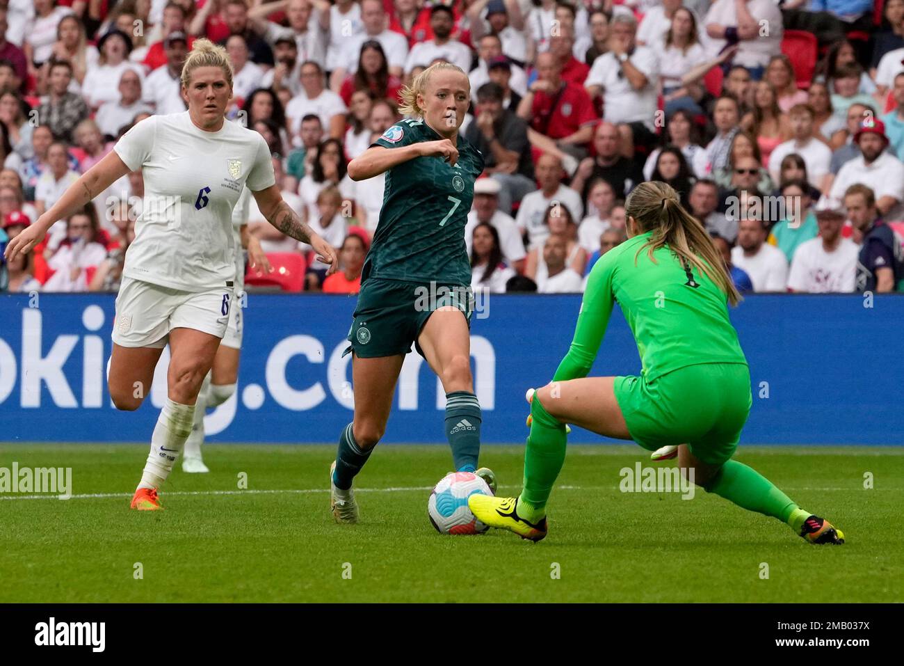 England's goalkeeper Mary Earps goes for a save in front of Germany's ...