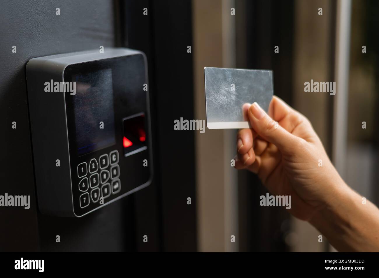 A woman opens the door with a plastic card. Modern keyless entry lock ...