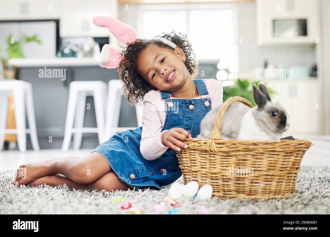 Some-bunny needs some chocolate. a little girl playing with a rabbit at ...