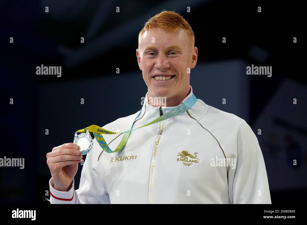 Tom Dean of England poses on the podium after winning the silver medal ...