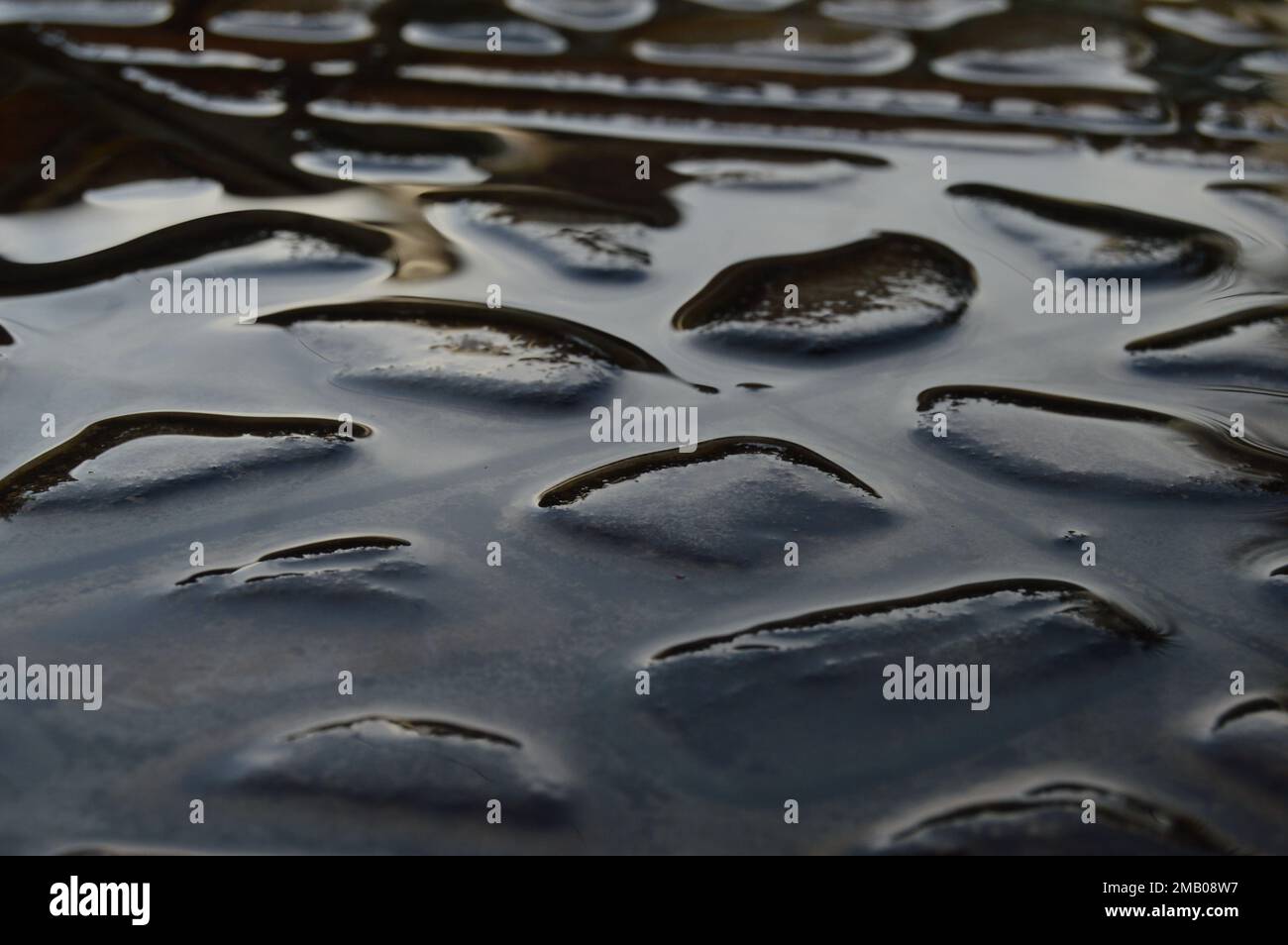 Puddles on the stone pattern tile floor in the front yard Stock Photo ...