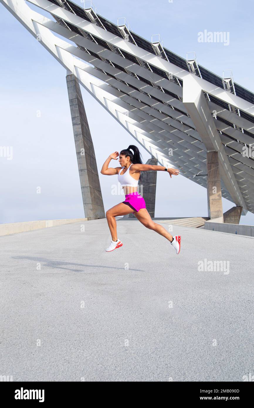 Athletic mixed race woman in action running through the city Stock ...