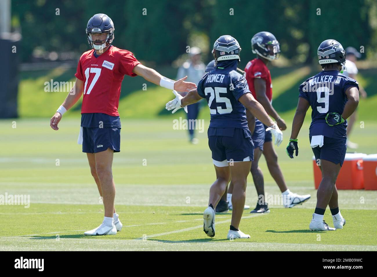 Seattle Seahawks quarterback Jacob Eason greets running back Travis ...