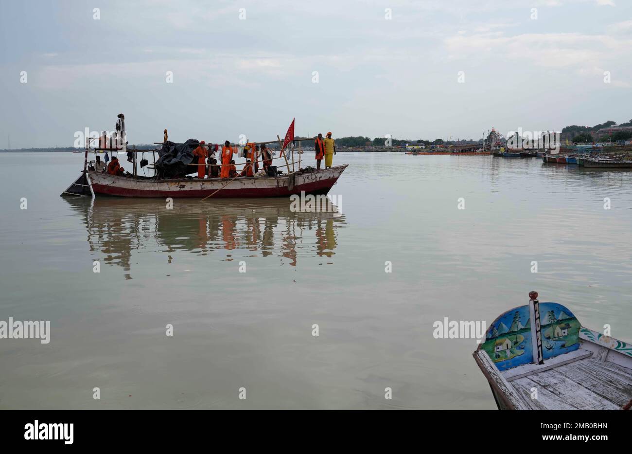 Hindu devotees ride a boat on the River Ganges, in Prayagraj, in the ...