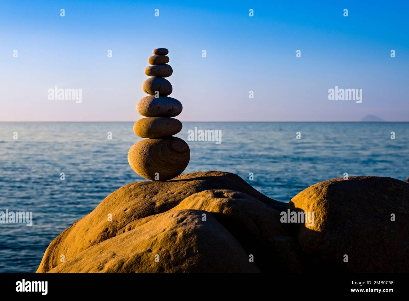 A well-balanced cairn on the beach of the small town of Castle di Tusa ...