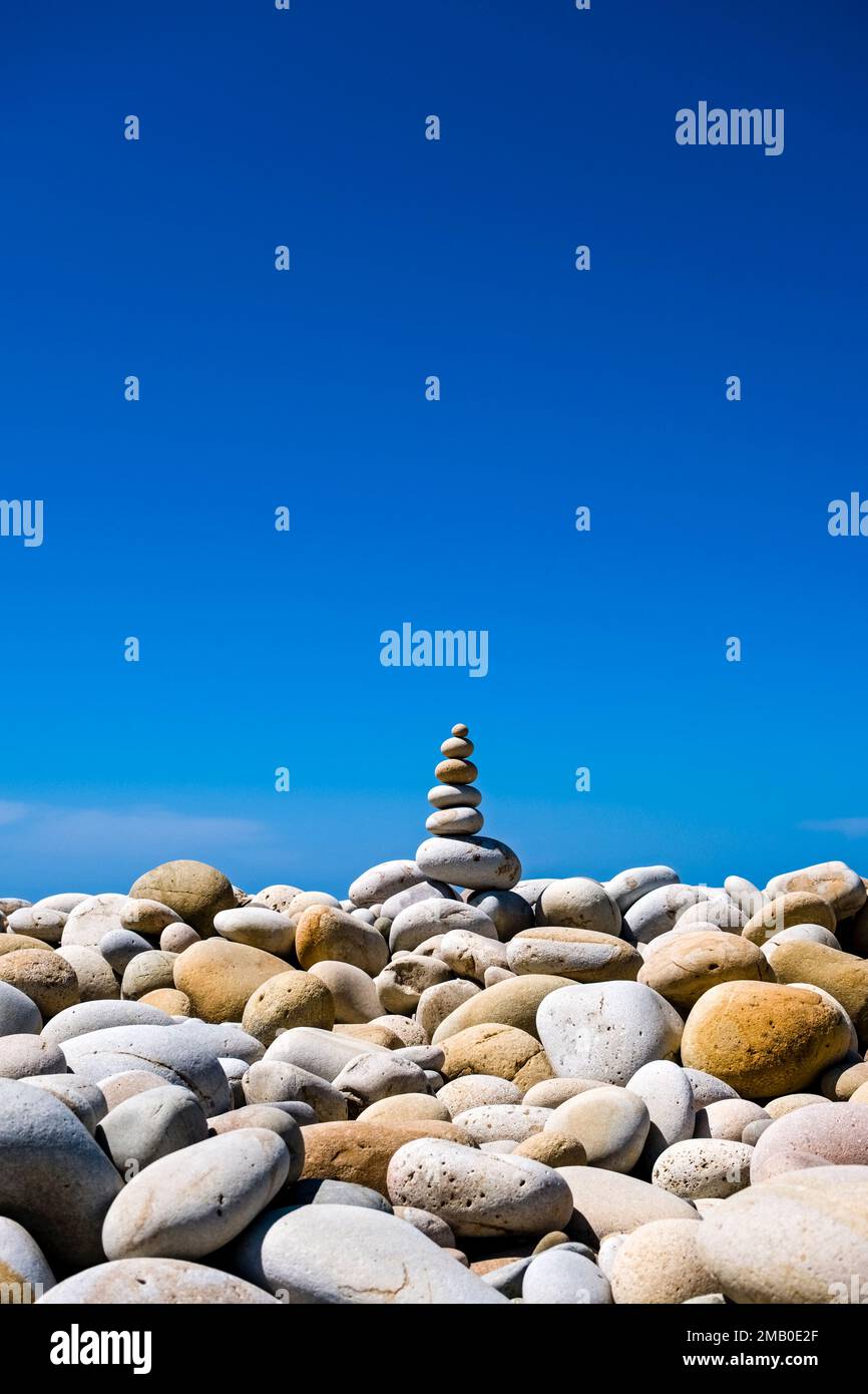 A well-balanced cairn on the beach of the small town of Castle di Tusa ...