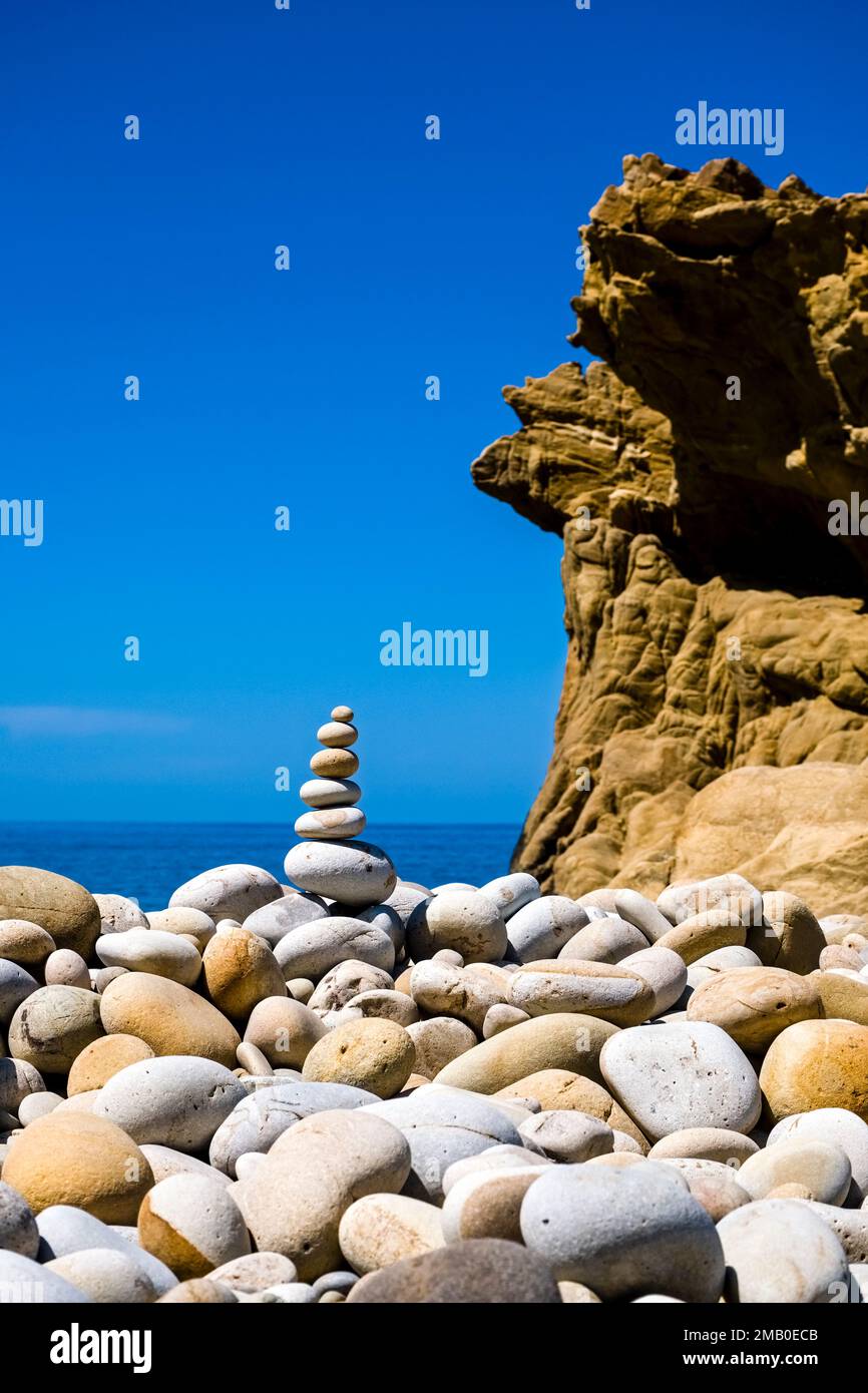 A well-balanced cairn on the beach of the small town of Castle di Tusa ...