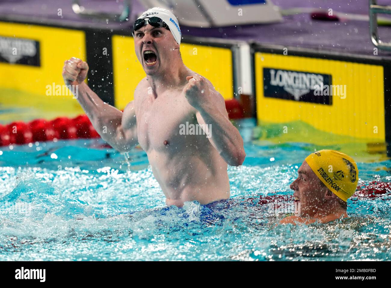 First position winner Zac Stubblety-Cook of Australia, right, watches ...