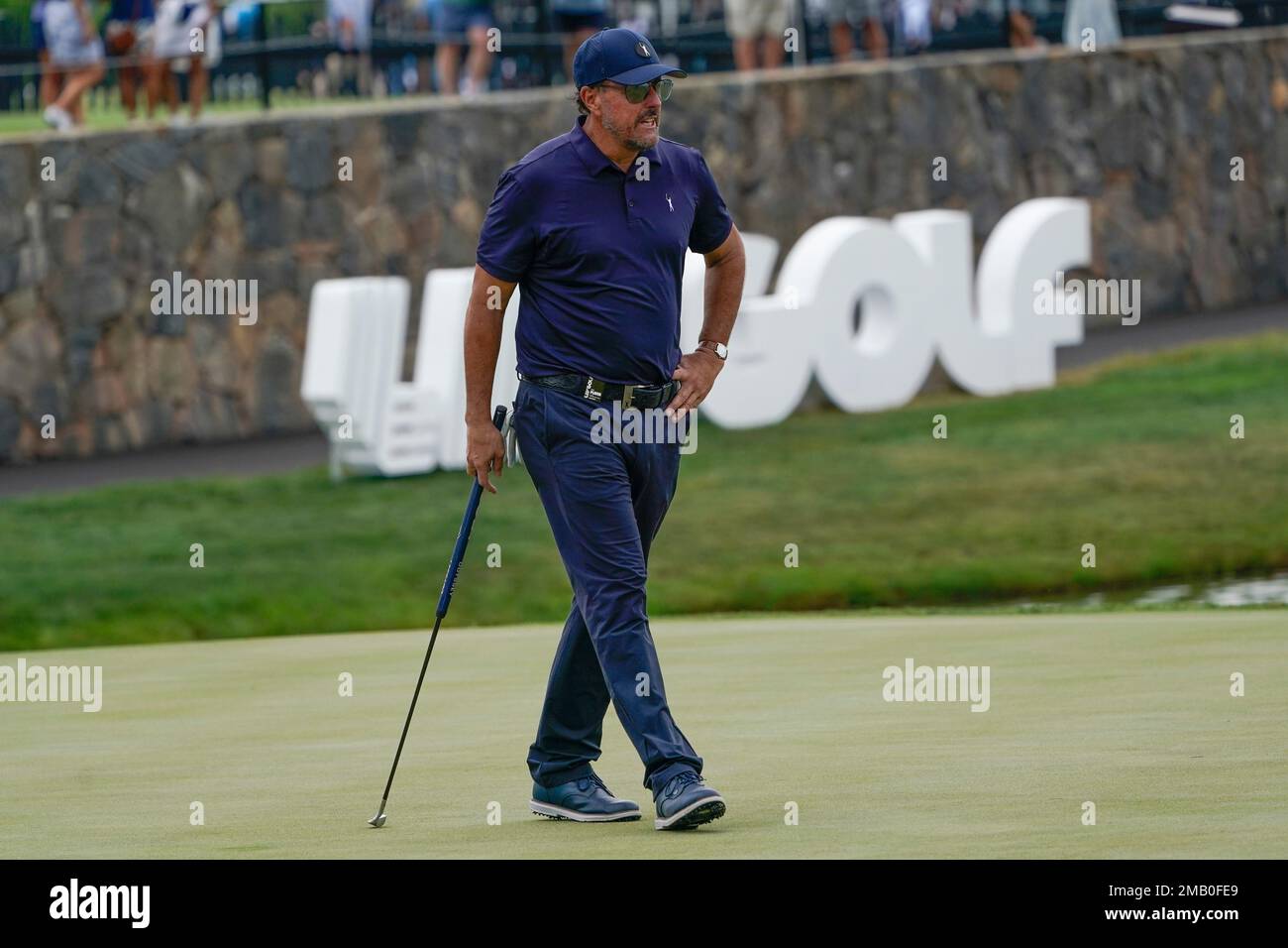 Phil Mickelson watches on the 18th hole during the first round of the ...