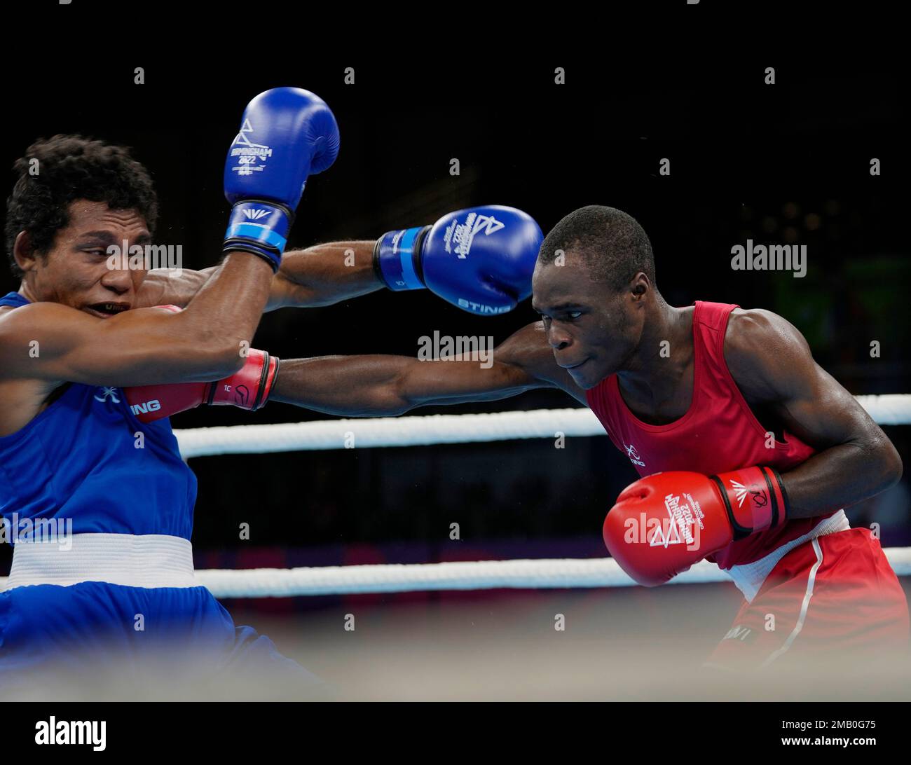 Malawi's Elias Rokobuli, right punches Papua New Guinea's John Ume ...