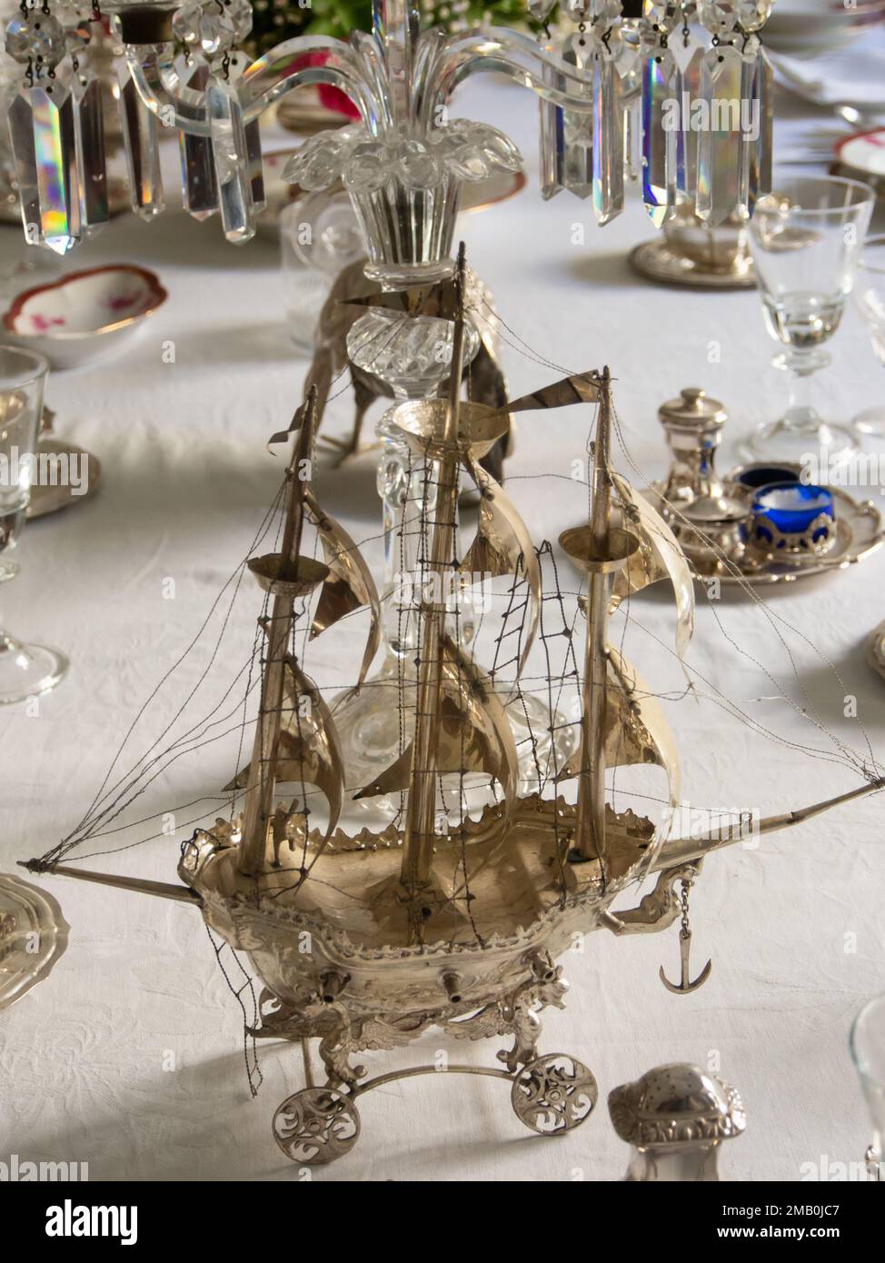 A vertical shot of a silver antique mast sailing ship sculpture on a ...