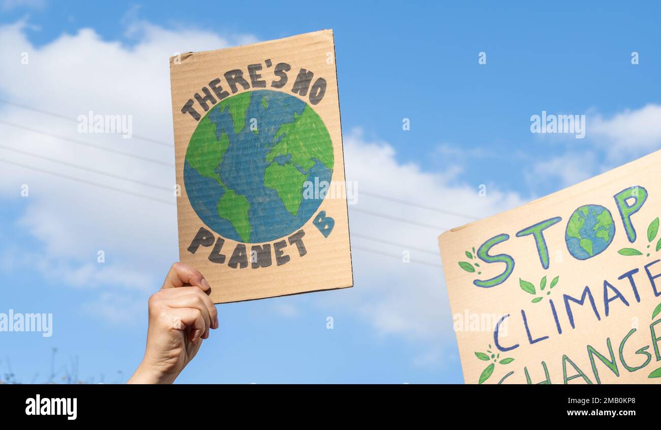 Protesters holding signs There's no planet B, Stop Climate Change ...