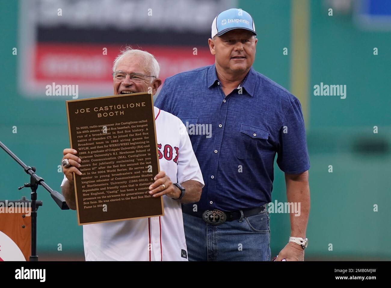 Boston Red Sox broadcaster Joe Castiglione, left, is accompanied by ...