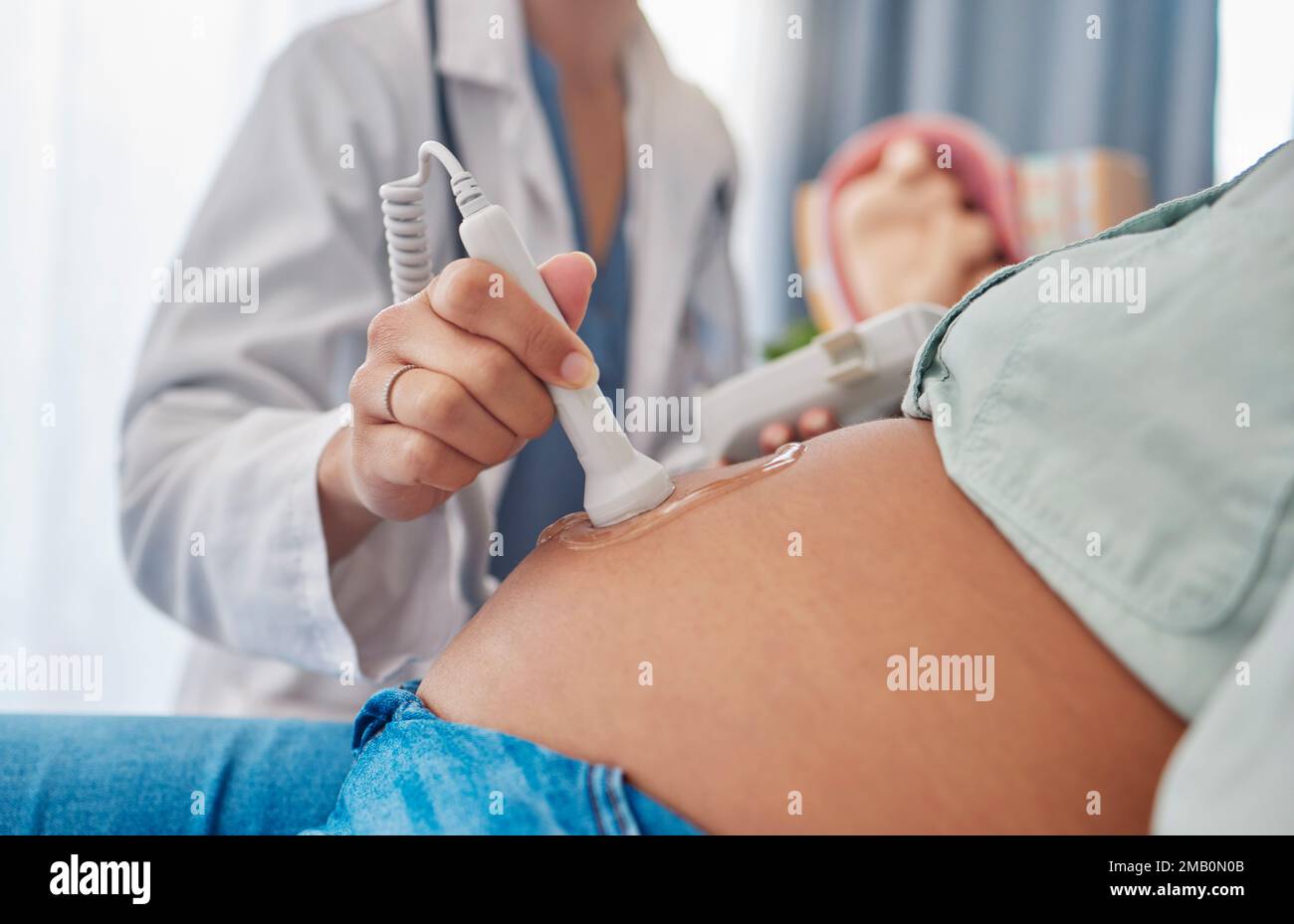 Pregnant woman, ultrasound and doctor hands with abdomen scan for baby ...