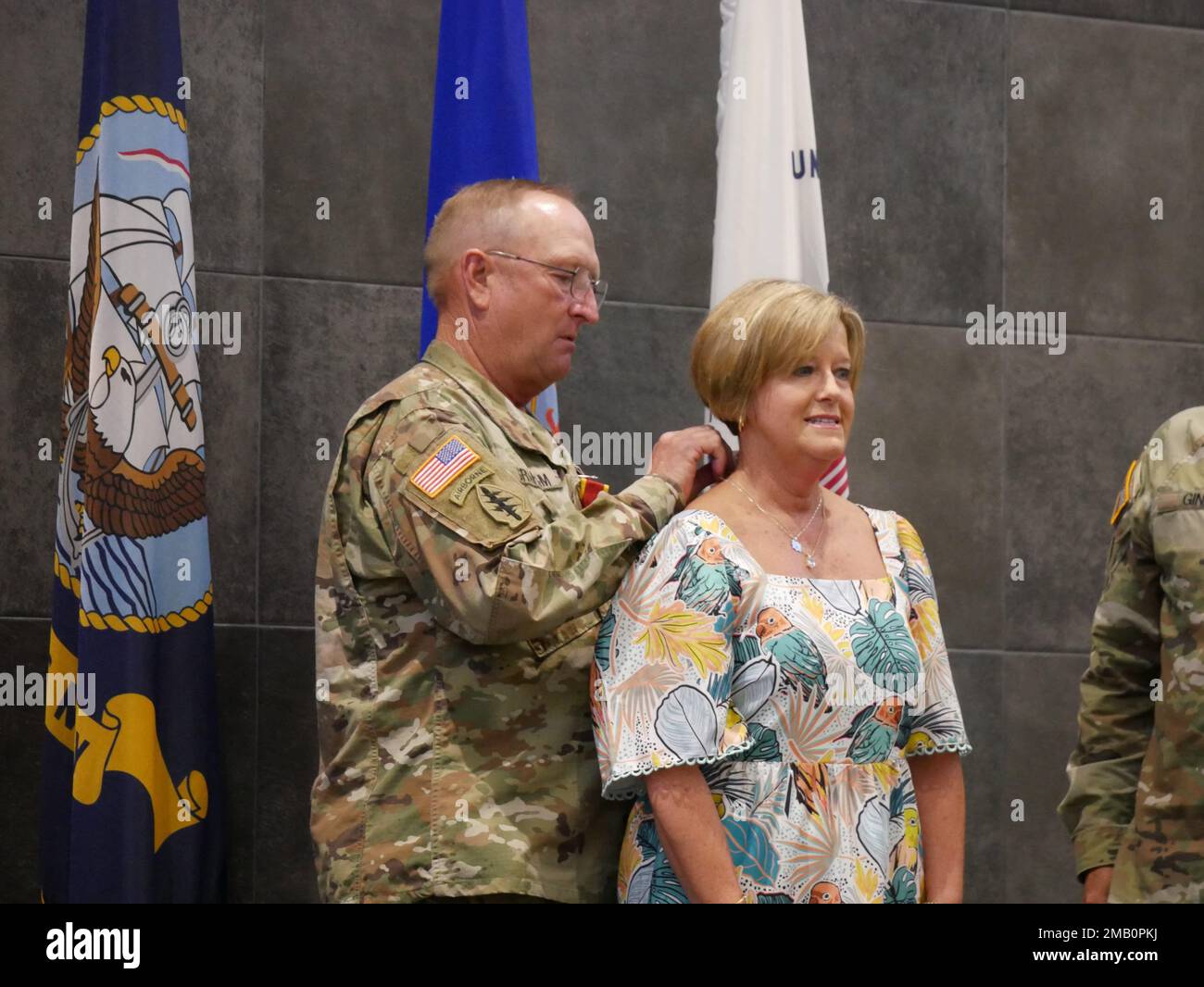 Chief Warrant Officer 5 Jimmy Graham presents his wife, Lisa, with the ...