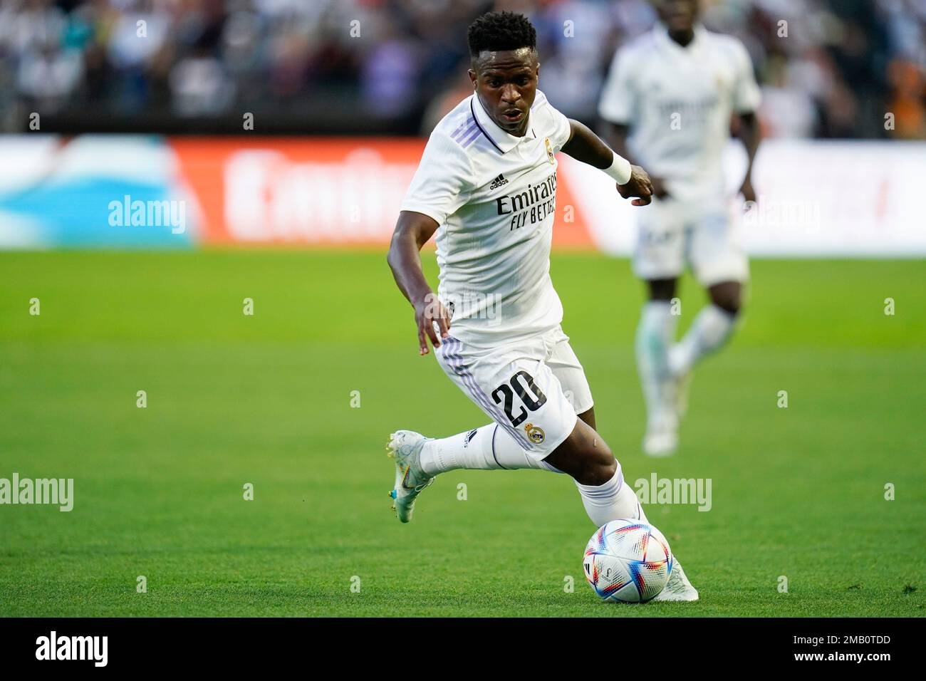 Real Madrid forward Vinícius Júnior (20) dribbles a ball upfield ...