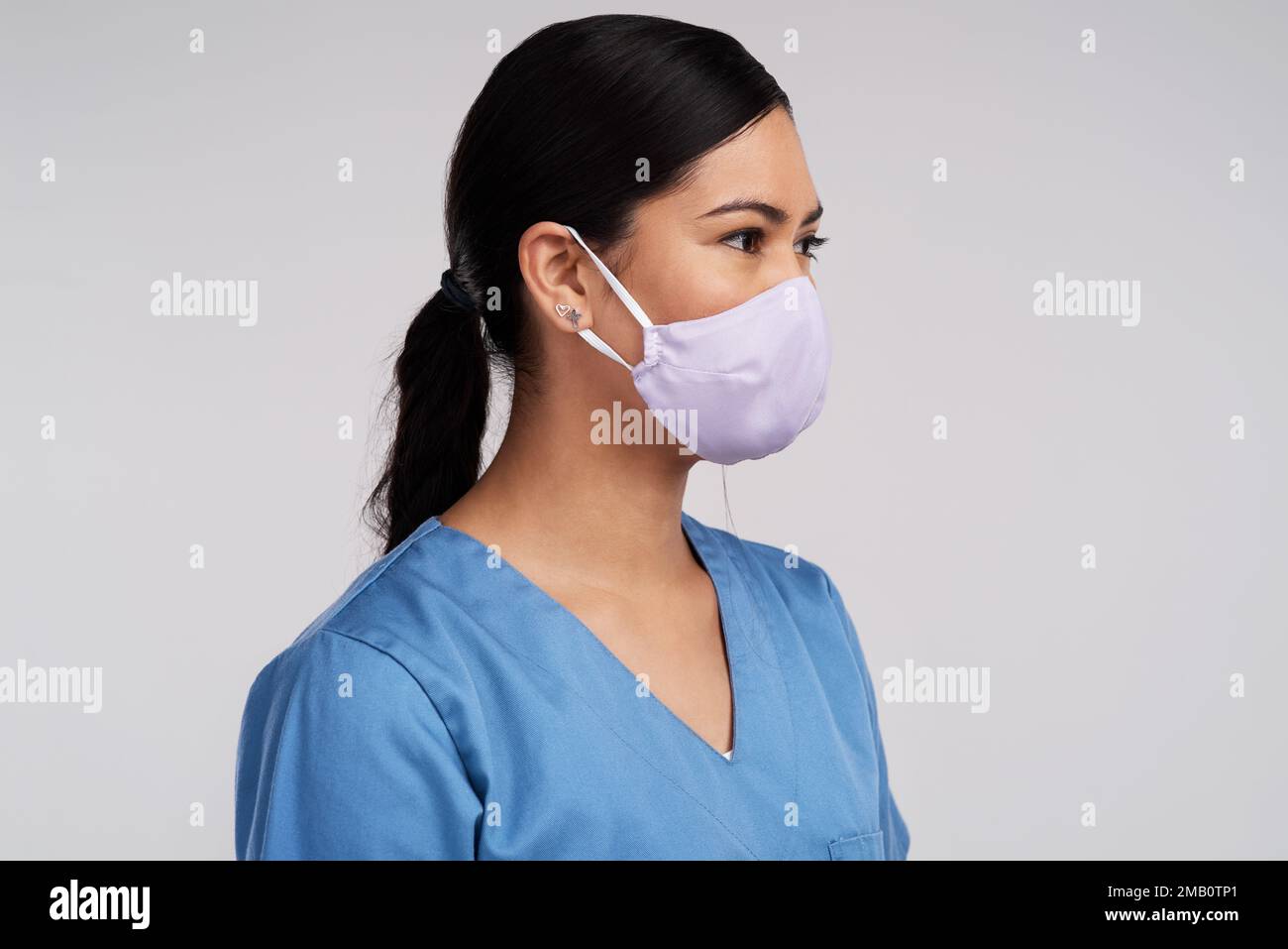 My uniform makes my heart smile. Side shot of a young doctor wearing a ...