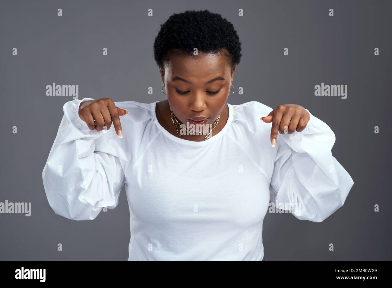 Woman pointing down hi-res stock photography and images - Alamy