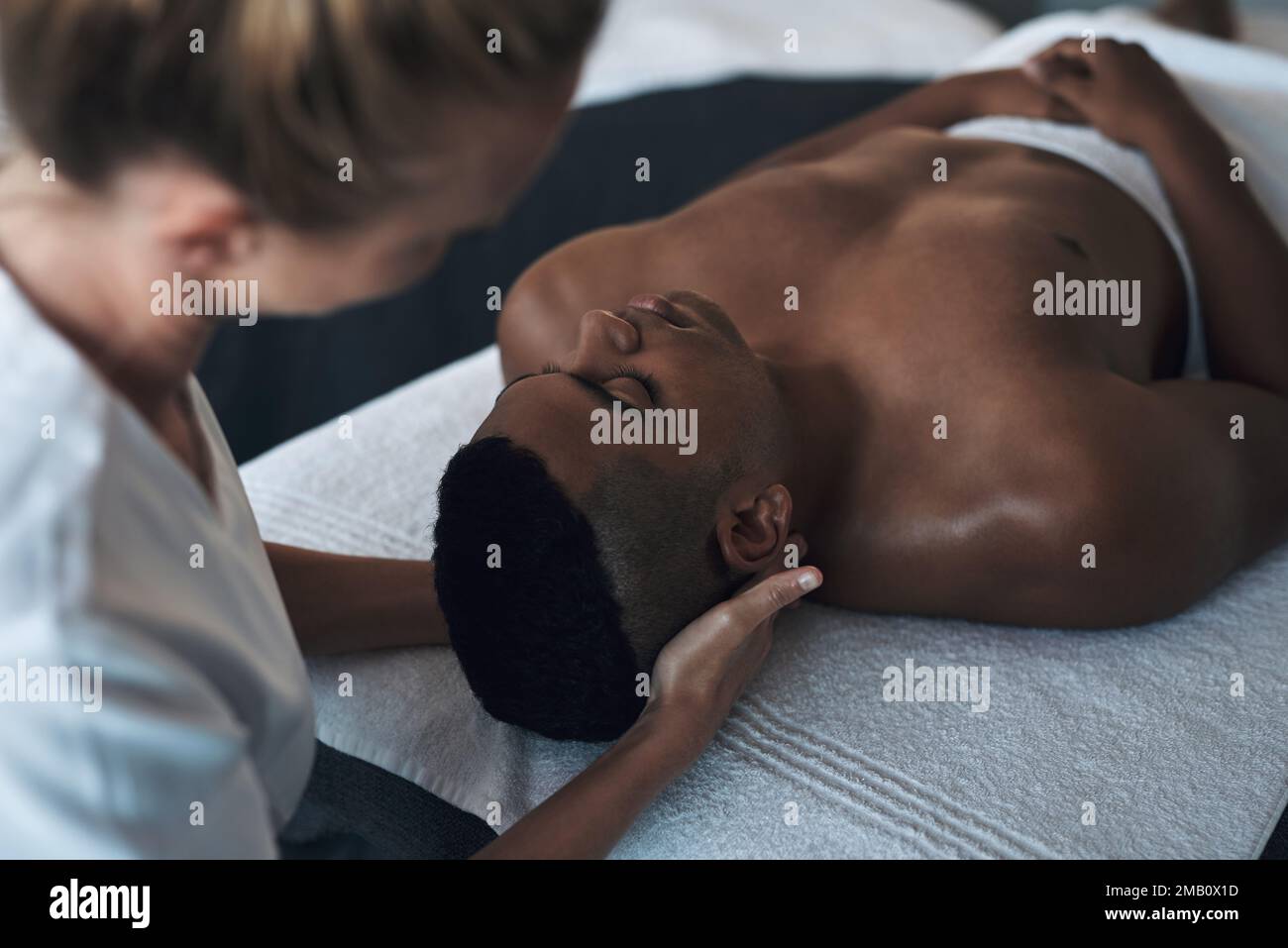 Drifting away into total relaxation. a young man getting a face massage ...