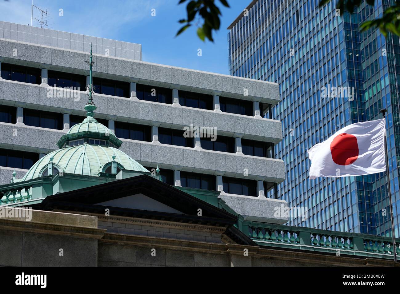 A Japanese flag flutters at the Bank of Japan headquarters in Tokyo ...