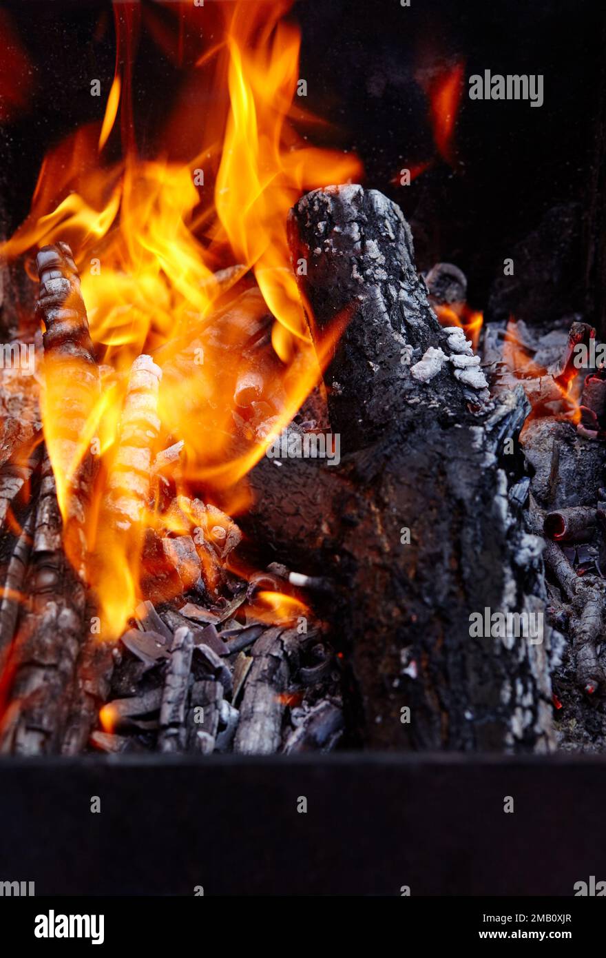 Burning red hot sparks fly from fire. Barbecue gril with glowing and ...