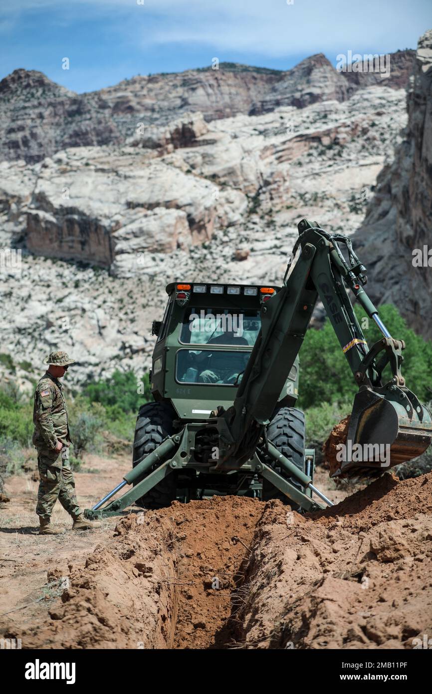 Spc. Christopher Starkey operates an excavator to dig a new water line ...