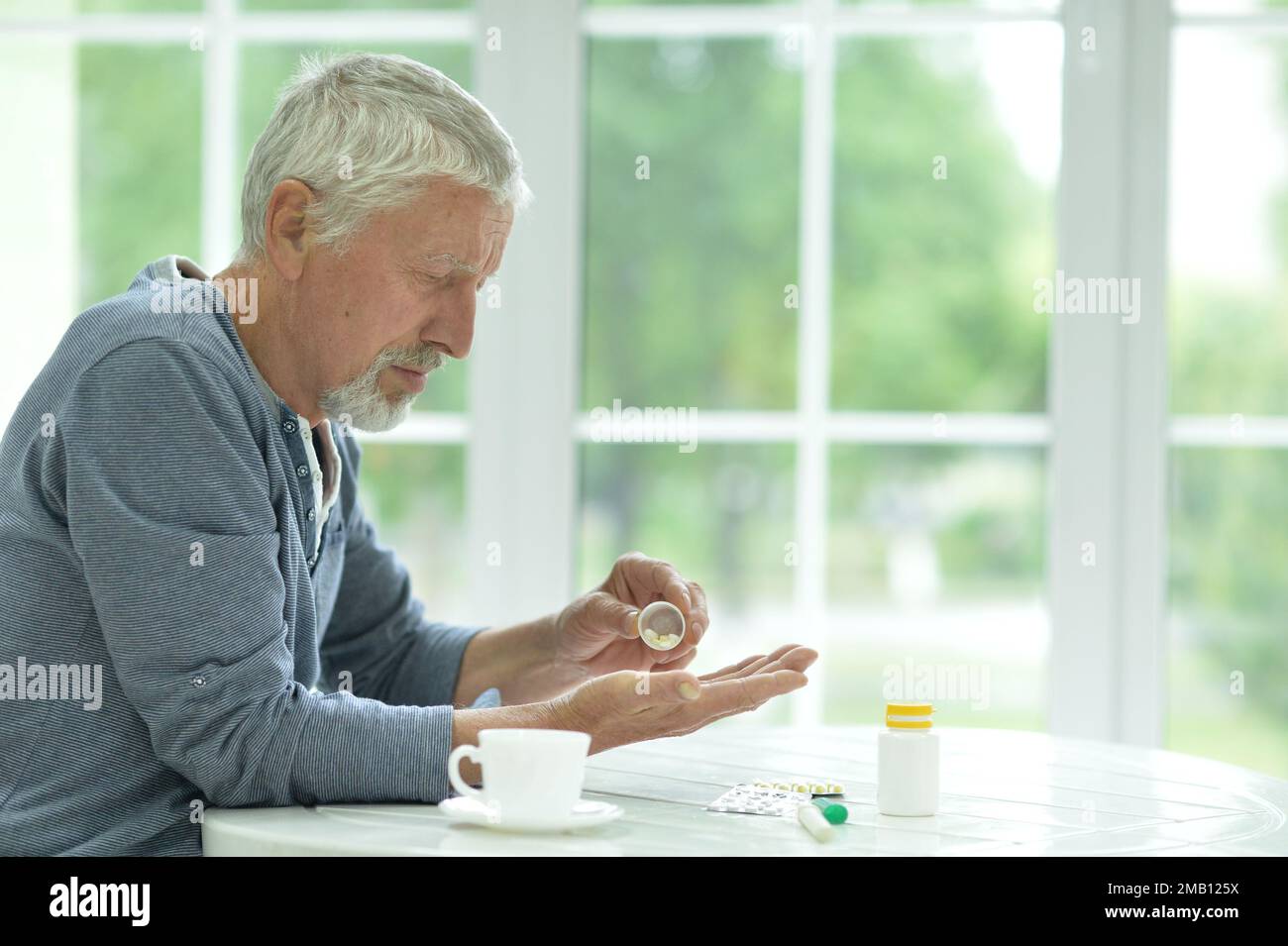 Portrait of sad sick old man with pills Stock Photo - Alamy
