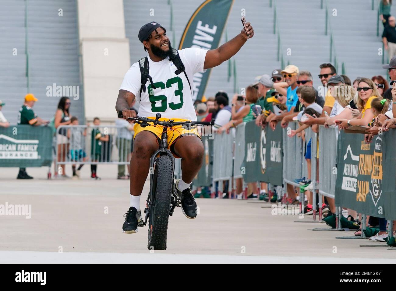 Green Bay Packers' Rasheed Walker takes a selfie as he rides a bike to ...