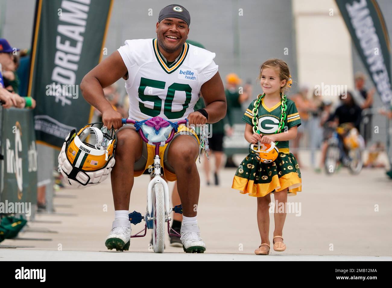 Green Bay Packers' Zach Tom rides a bike to the NFL football team's ...