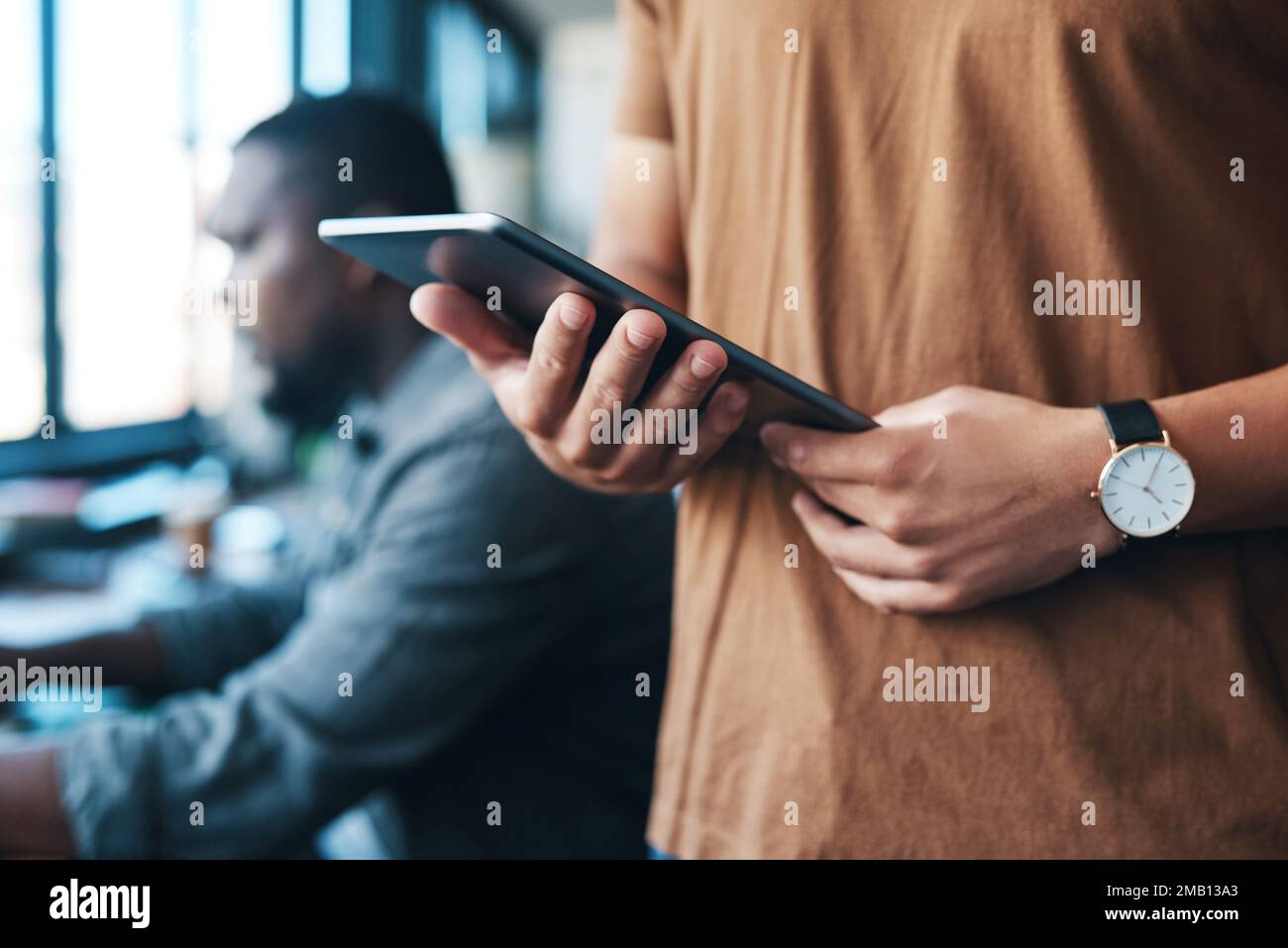 Such a tiny device can do so many things. an unrecognizable businessman ...