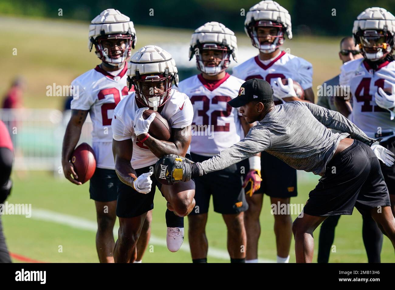 Washington Commanders running back Brian Robinson, second from left ...