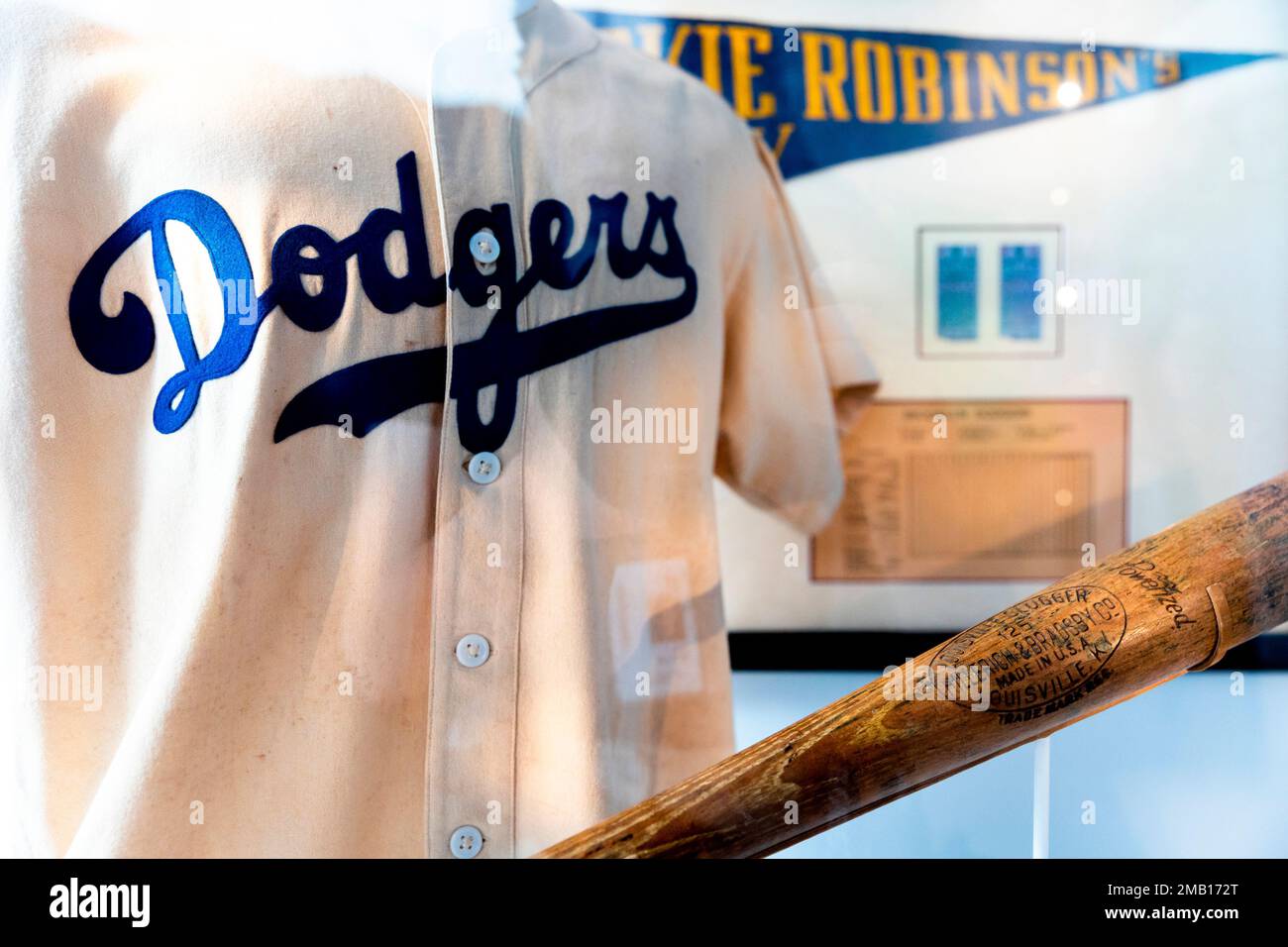 A Jackie Robinson's Brooklyn Dodgers uniform and bat on display at the ...