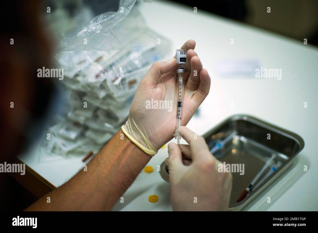 A health professional prepares syringes with vaccines against Monkeypox ...