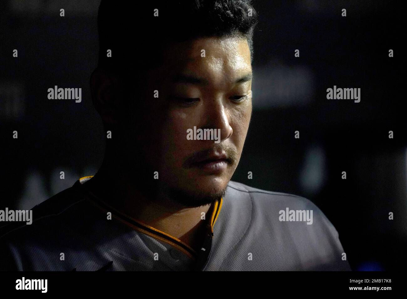 Pittsburgh Pirates' Yoshi Tsutsugo stands in the dugout in a baseball ...