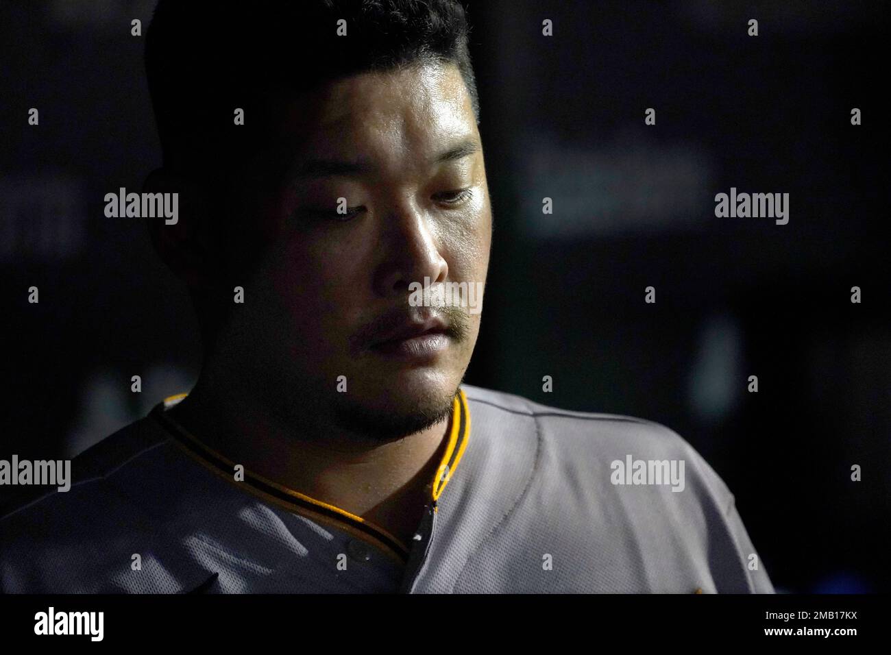 Pittsburgh Pirates' Yoshi Tsutsugo stands in the dugout in a baseball ...