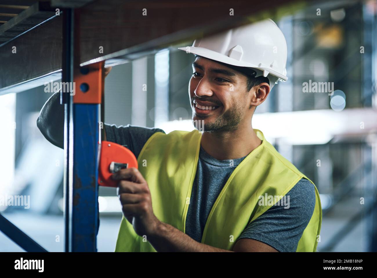 Keeping safety standards up to scratch. a young builder using a ...