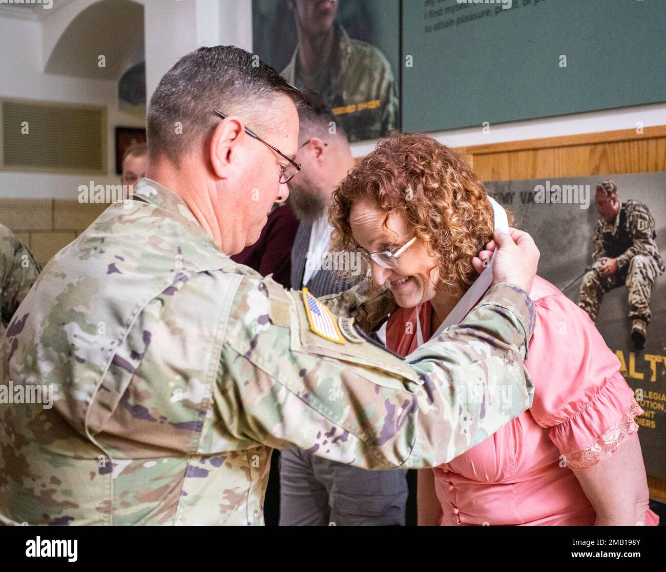 Col. Micheal Kimball hangs a Civilian Service Commendation medal on ...