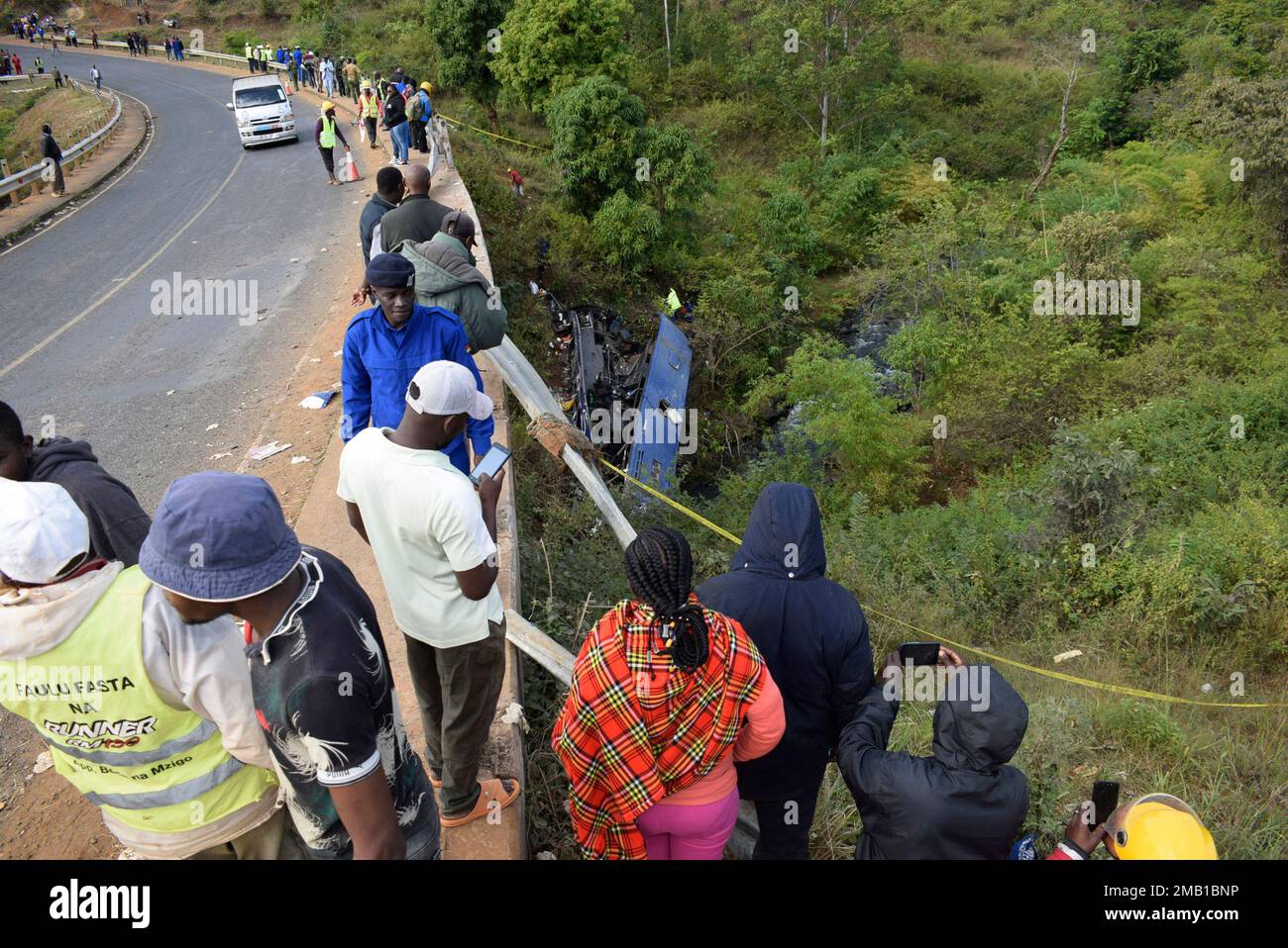 People look at the wreckage of a bus that plunged into Nithi bridge on ...